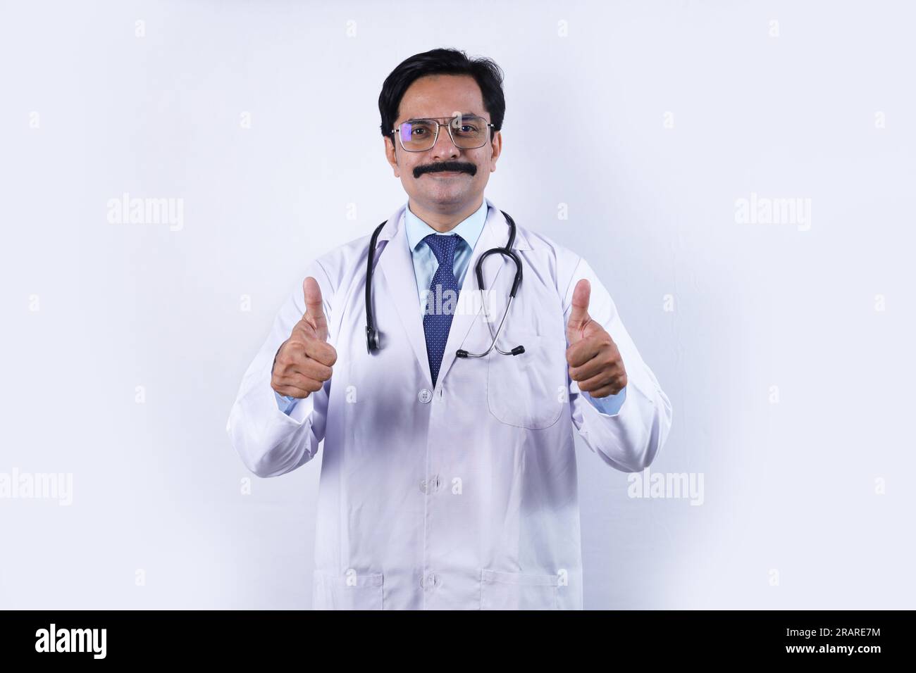 Portrait of happy Indian doctor in uniform wearing stethoscope and ...