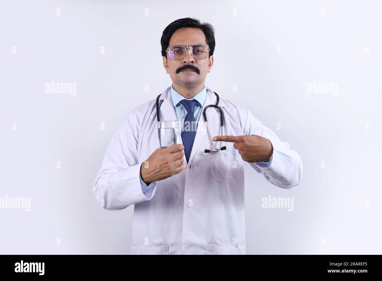 Indian confident Doctor holding a health drink in hand and suggesting ...