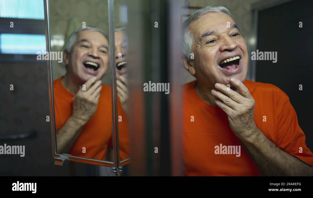 Happy senior man looking at himself in mirror reflection. Joyful ...