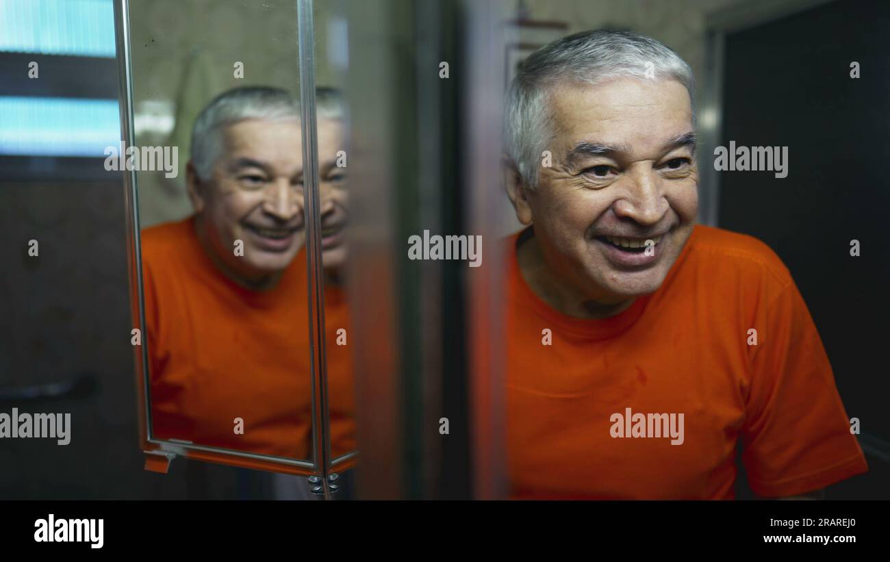 Happy senior man looking at himself in mirror reflection. Joyful ...
