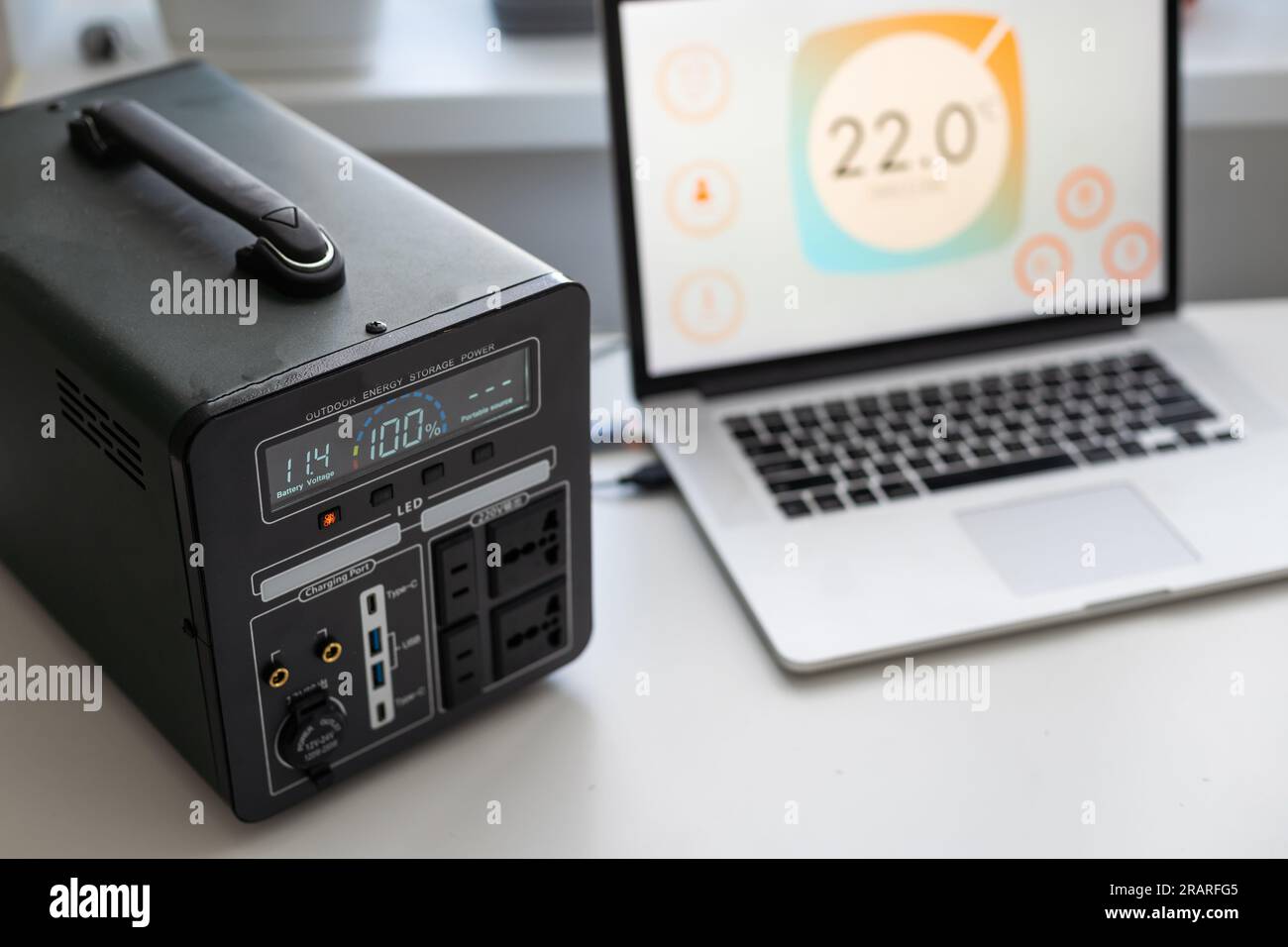 Portable power station charging devices on floor in living room Stock ...