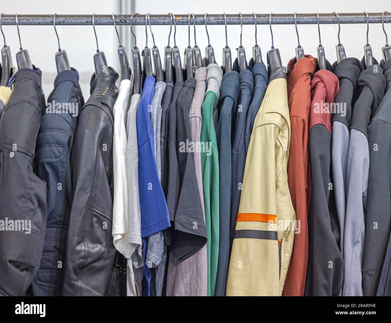 Cotton Shirts Hoodie and Leather Jackets Hanging at Railing Man Fashion ...