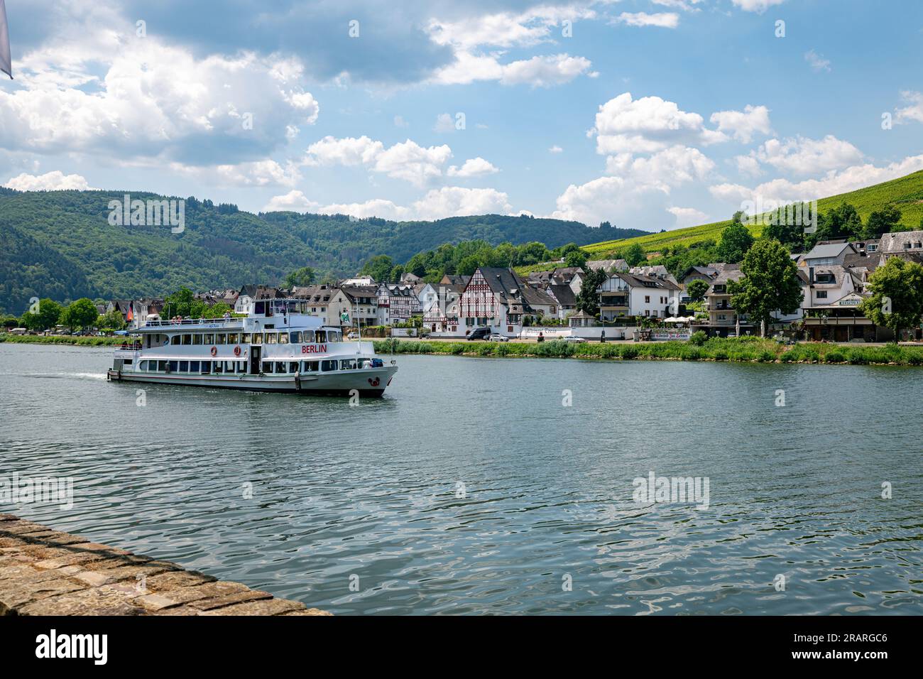 the german village of Zell with a boat and mountains on the background ...