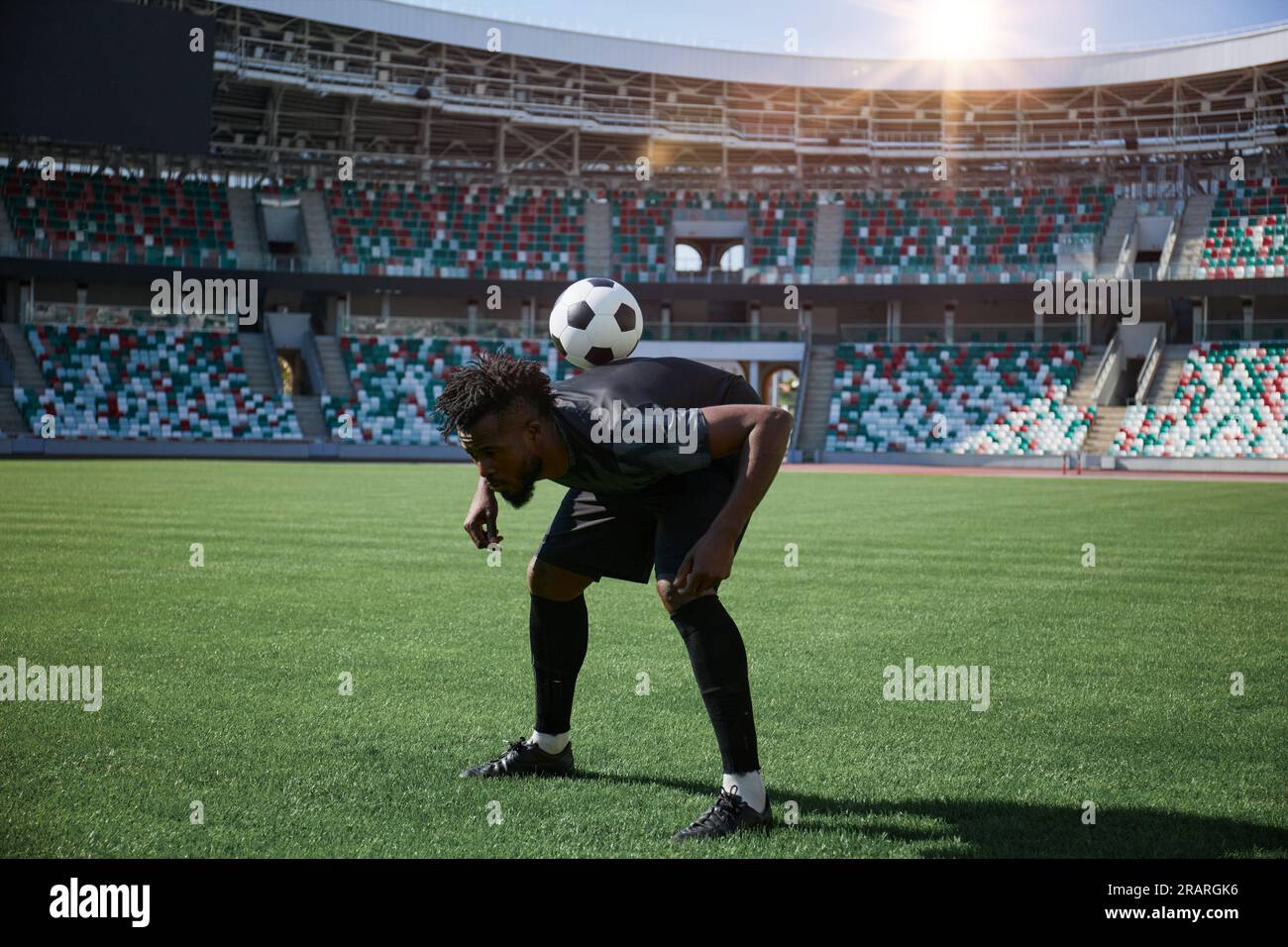 one football player is training holding the ball with his back Stock ...