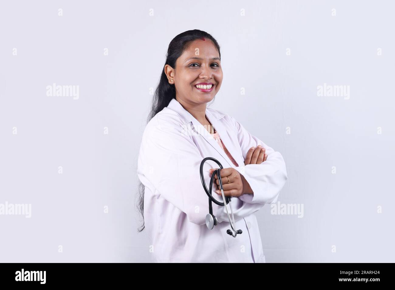 Portrait of happy Indian doctor in uniform wearing stethoscope and ...