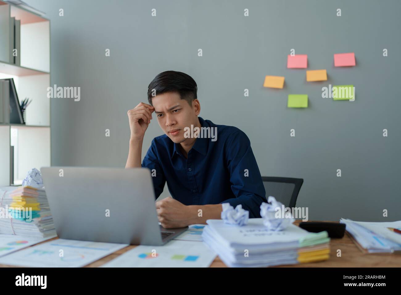 Portrait of business owner, man using computer and financial statements ...