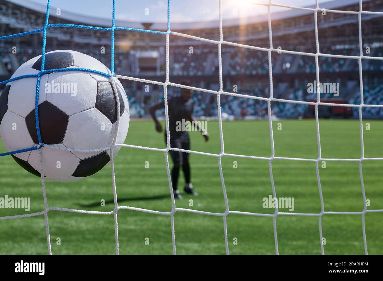 soccer player kicks the ball into the goal at the stadium Stock Photo ...