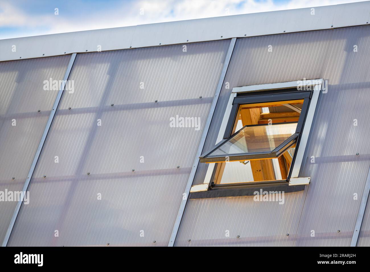open window in the roof of the greenhouse. Greenhouse - an extension or ...