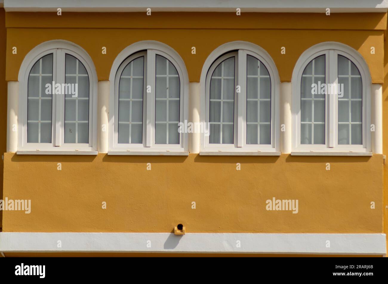 four white windows with arch at the top, symmetry Stock Photo - Alamy