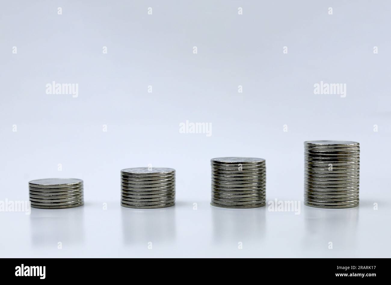 Four stacks of coins with white background. concept of business ...