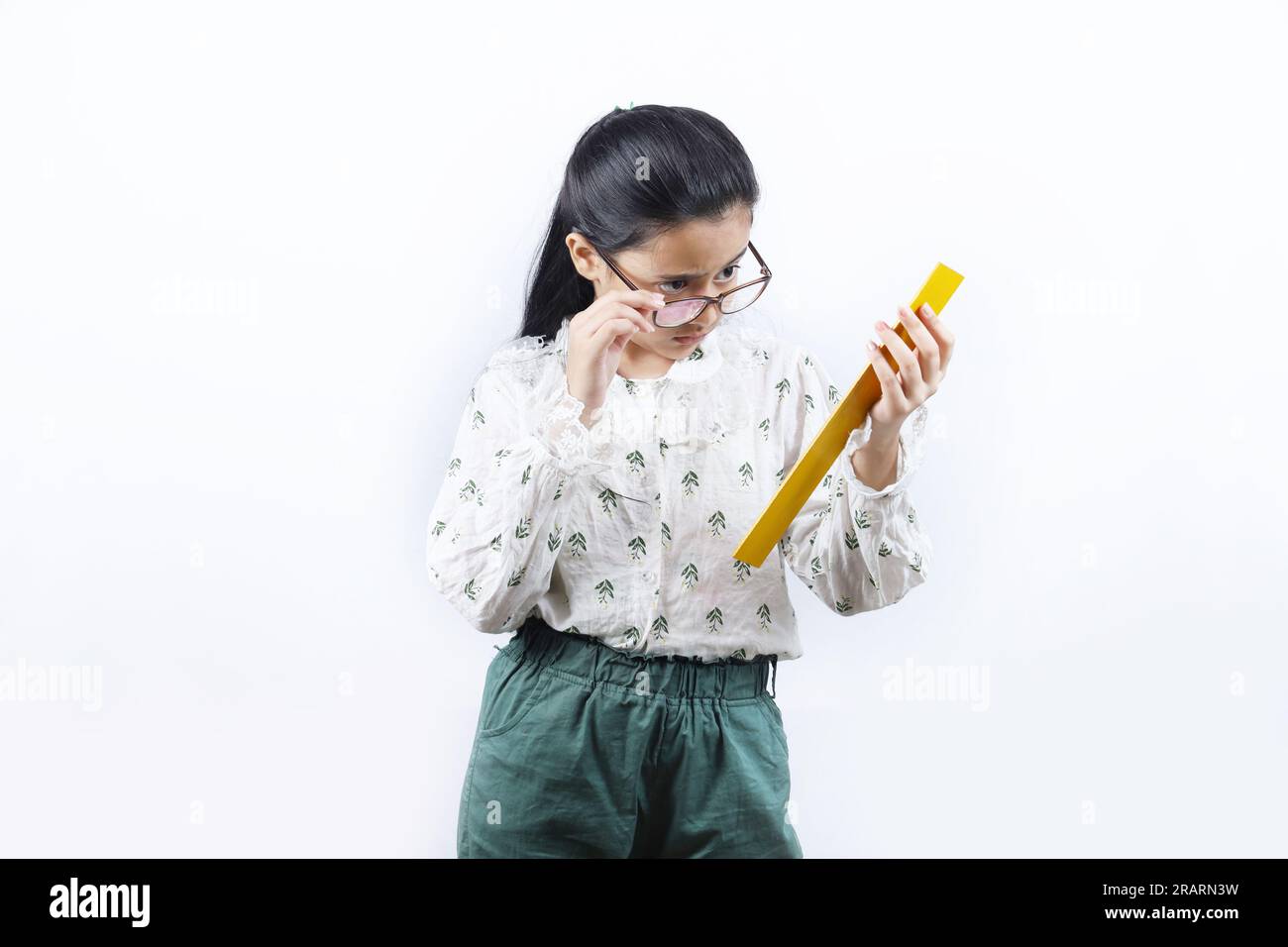 Young girl teaching. Portrait of Happy Indian teenage girl holding a ...