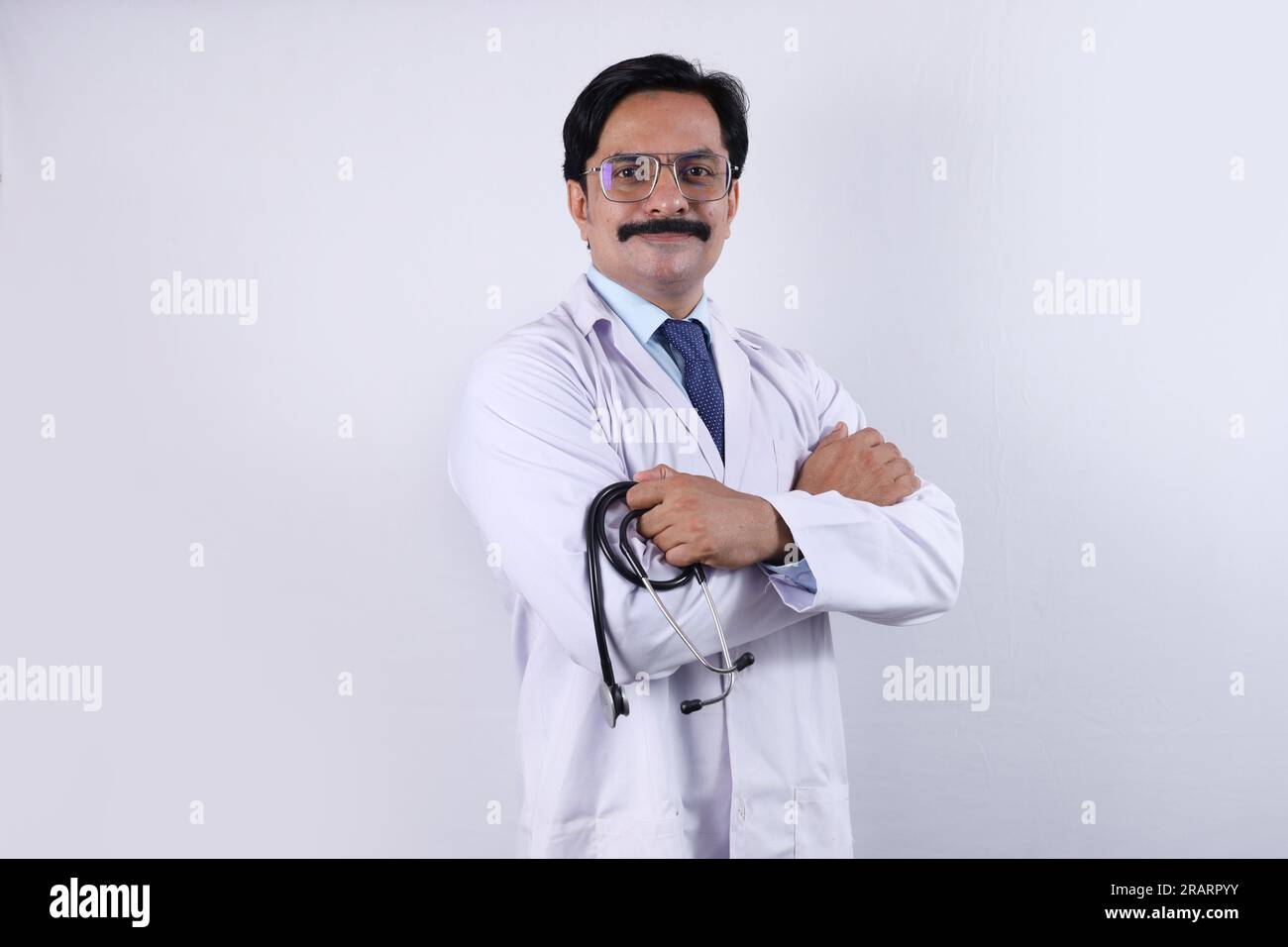 Portrait of happy Indian doctor in uniform wearing stethoscope and ...