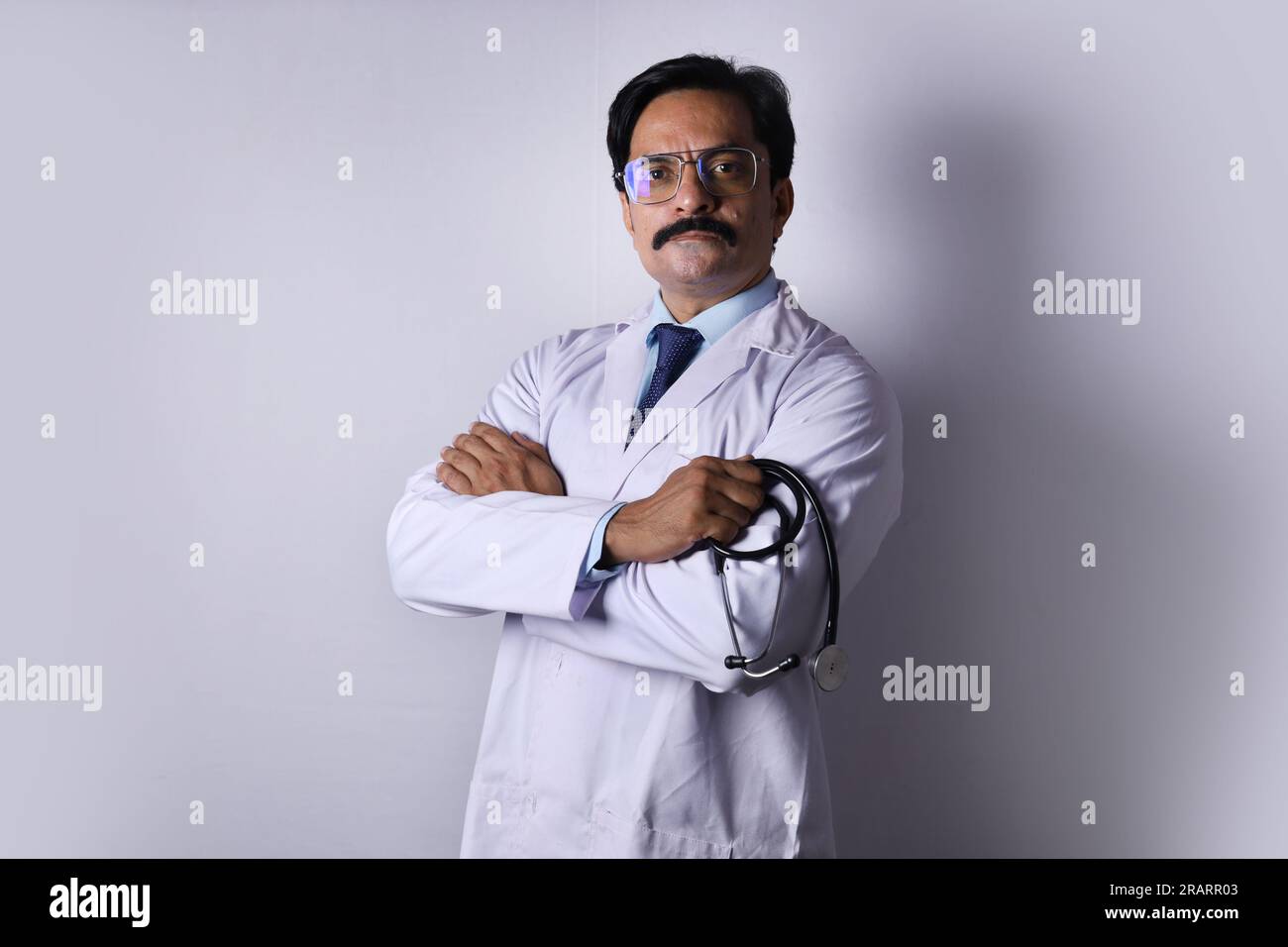 Portrait of happy Indian doctor in uniform wearing stethoscope and ...
