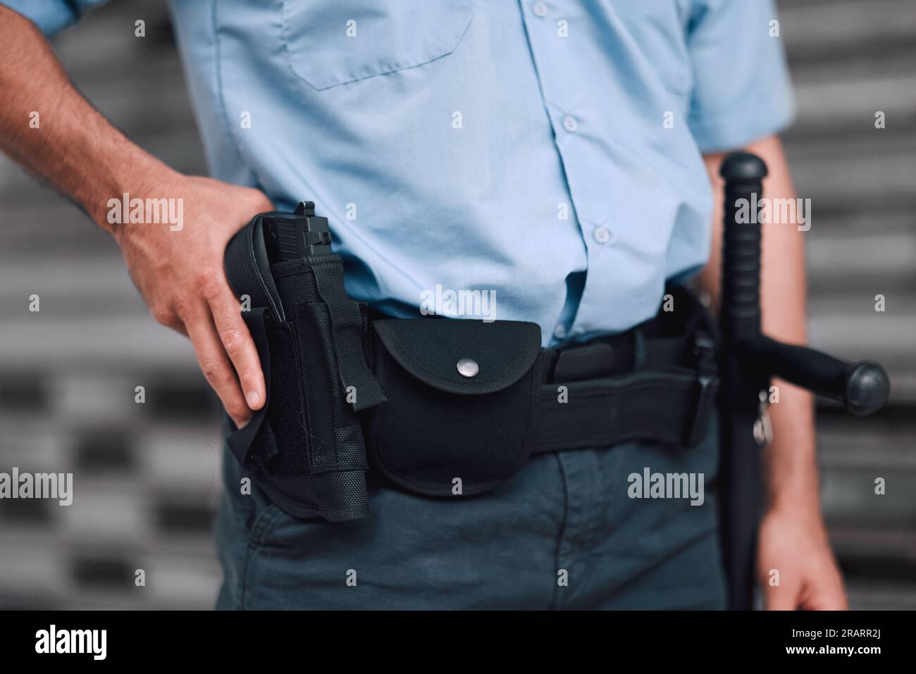 Hand, gun and security with an officer on duty or patrol in the city ...