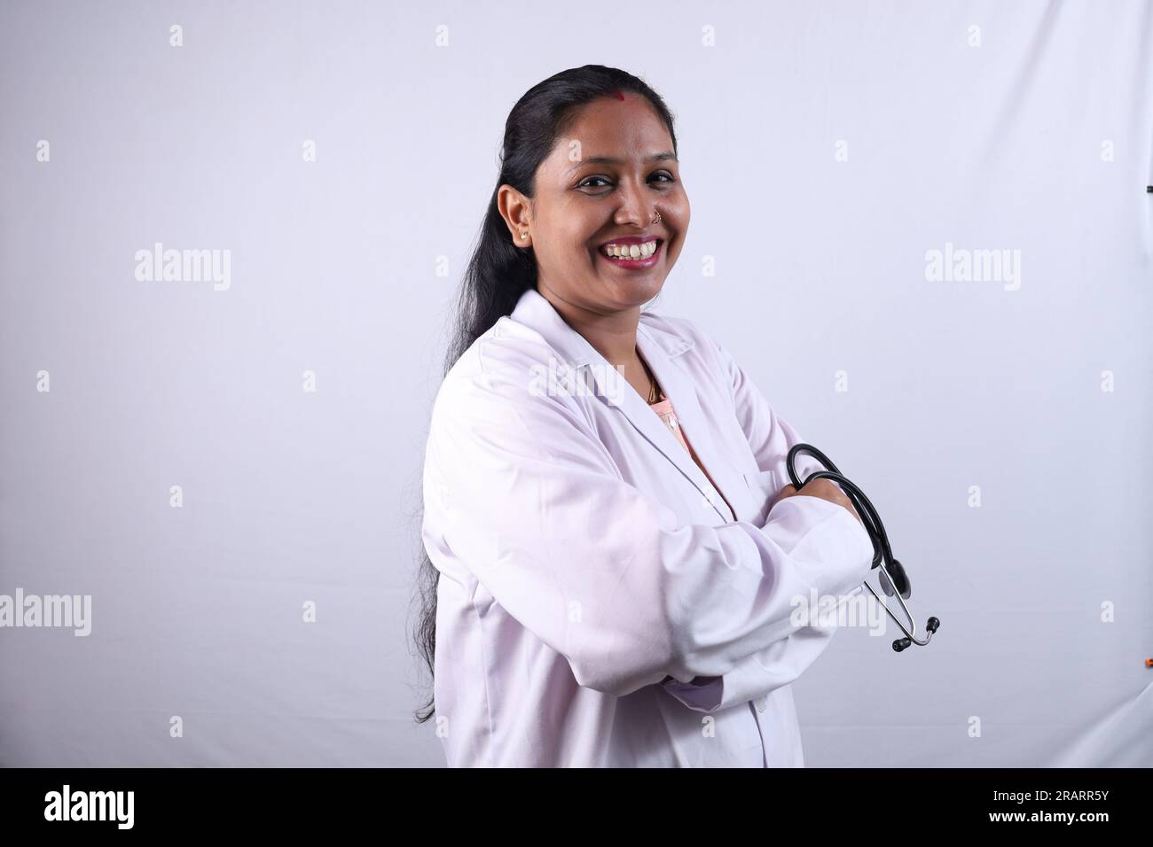 Portrait of happy Indian doctor in uniform wearing stethoscope and ...