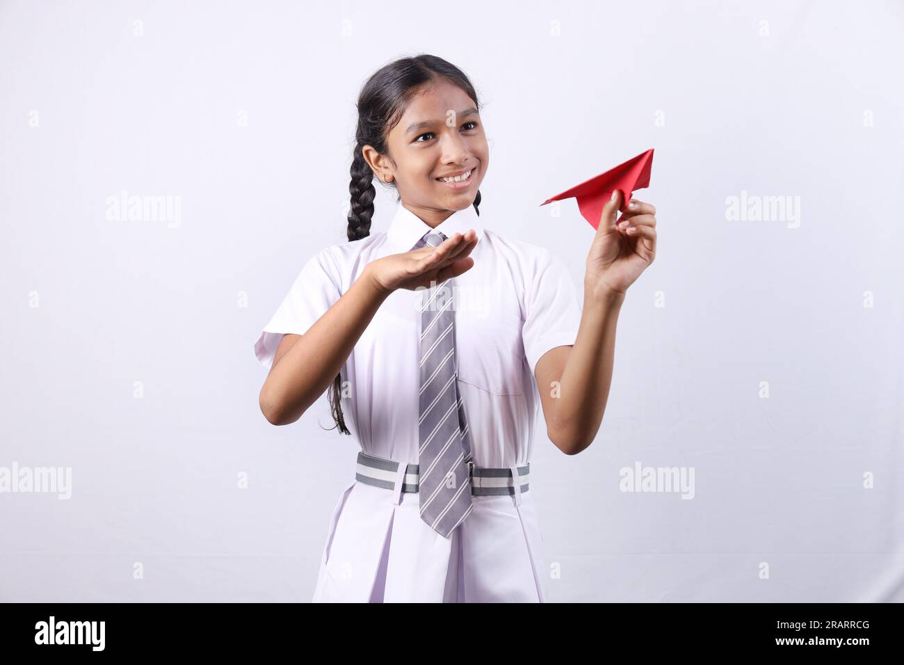 Happy Indian school kid playing with paper airplane and dreaming about ...