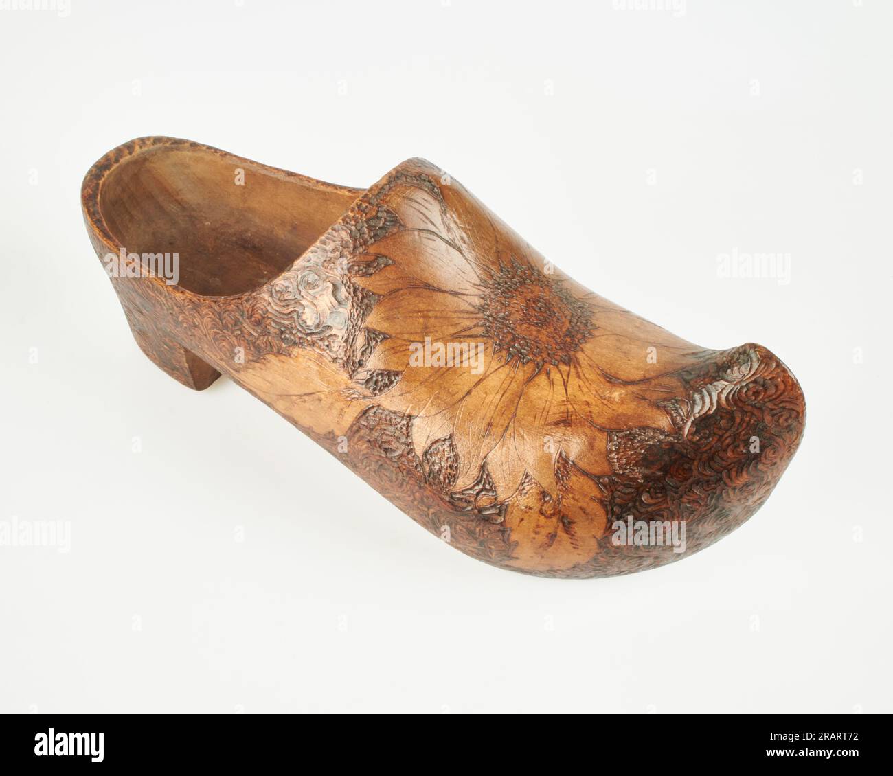 Antique sunflower poker work wooden clog Stock Photo - Alamy
