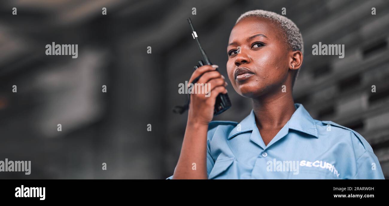 Security, radio and a black woman police officer in the city during her ...