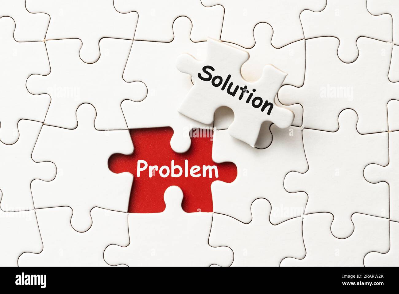 Problem solution concept using white jigsaw puzzle Stock Photo - Alamy