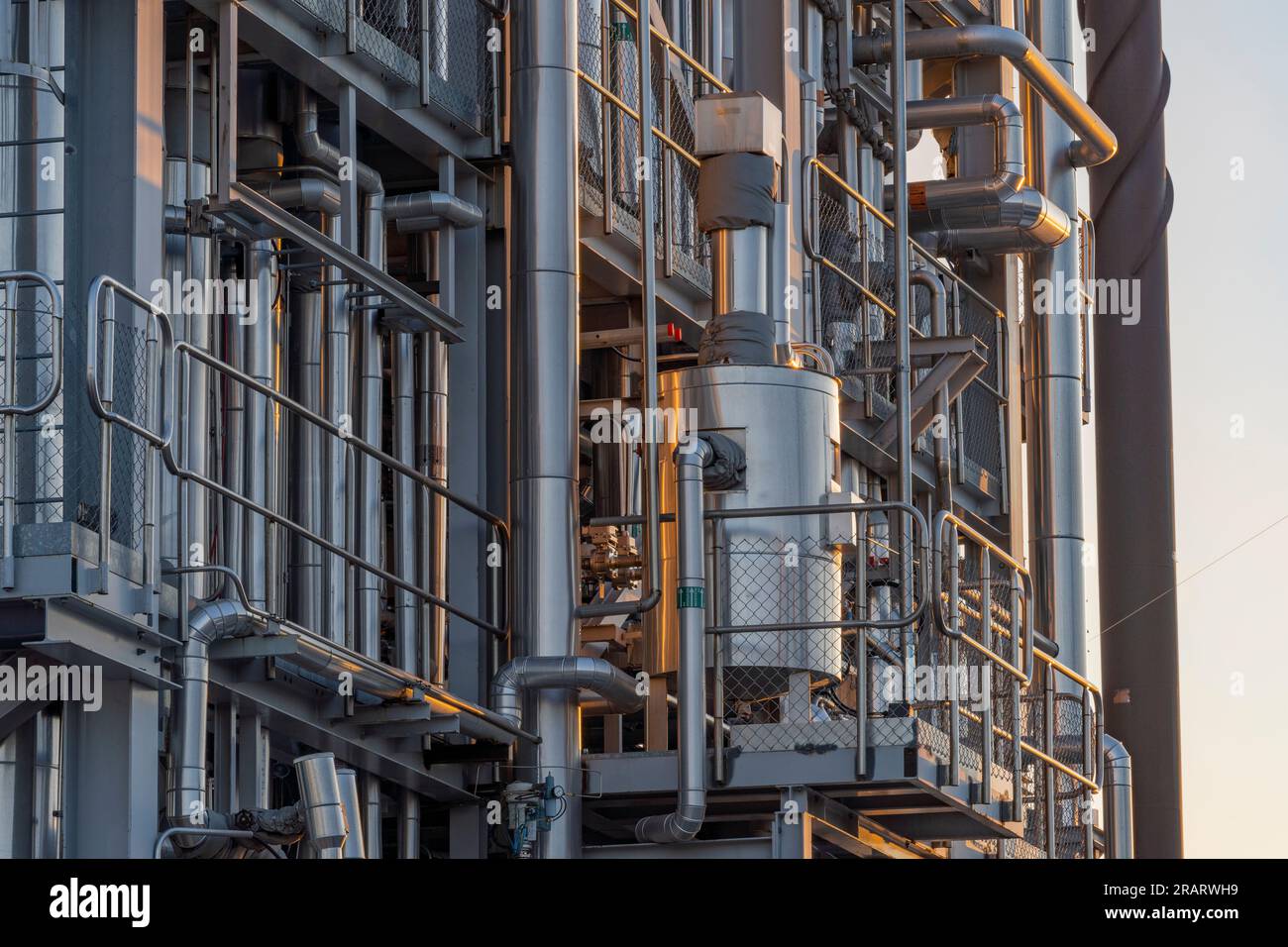 Industrial Pipelines details up close during sunset at paper mill ...