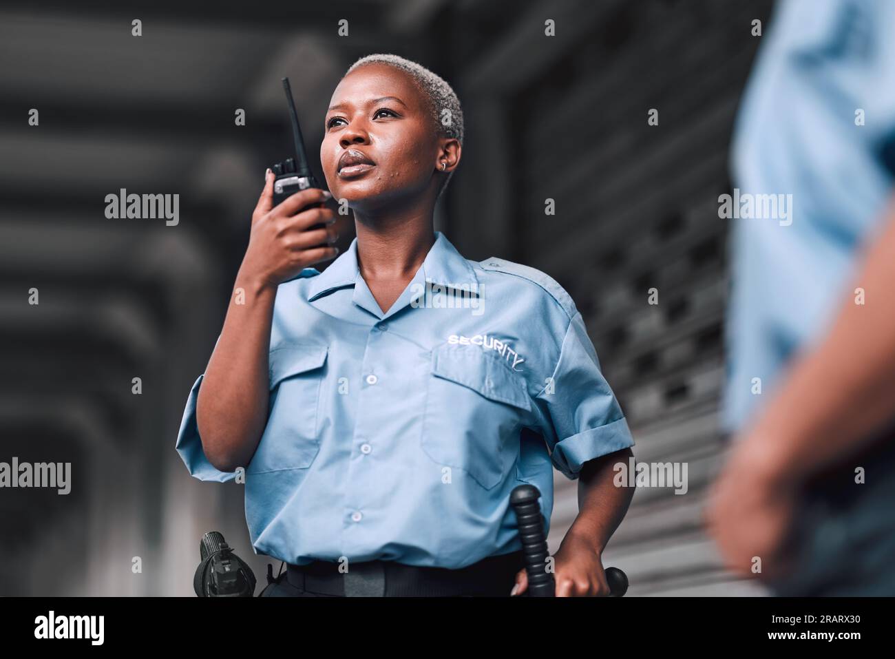 Police, communication and black woman law enforcement worker talking on ...