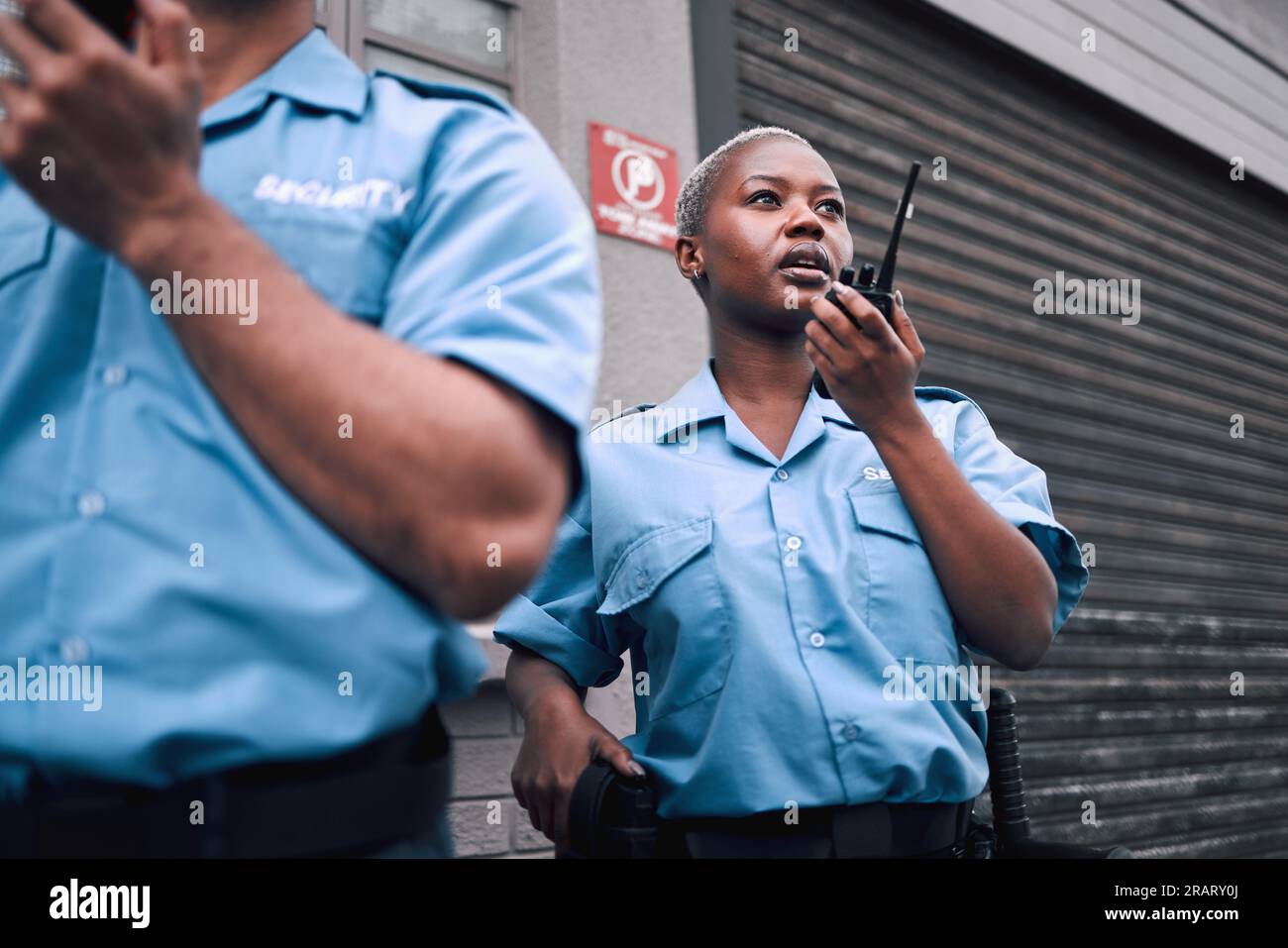 Security, walkie talkie and a black woman police officer in the city ...
