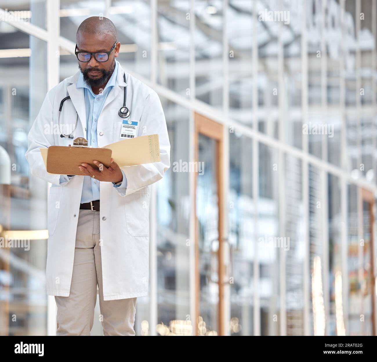 Black man, doctor and reading notes on clipboard with research ...
