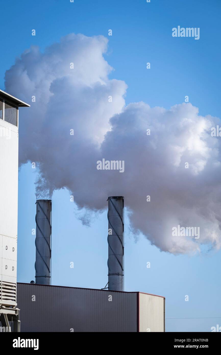 buildings and chimneys with smoke from the industrial process on blue ...