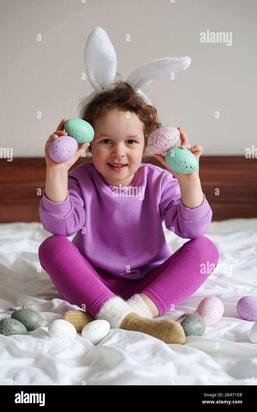 Happy Easter. cute beautiful girl with curly hair and bunny ears ...