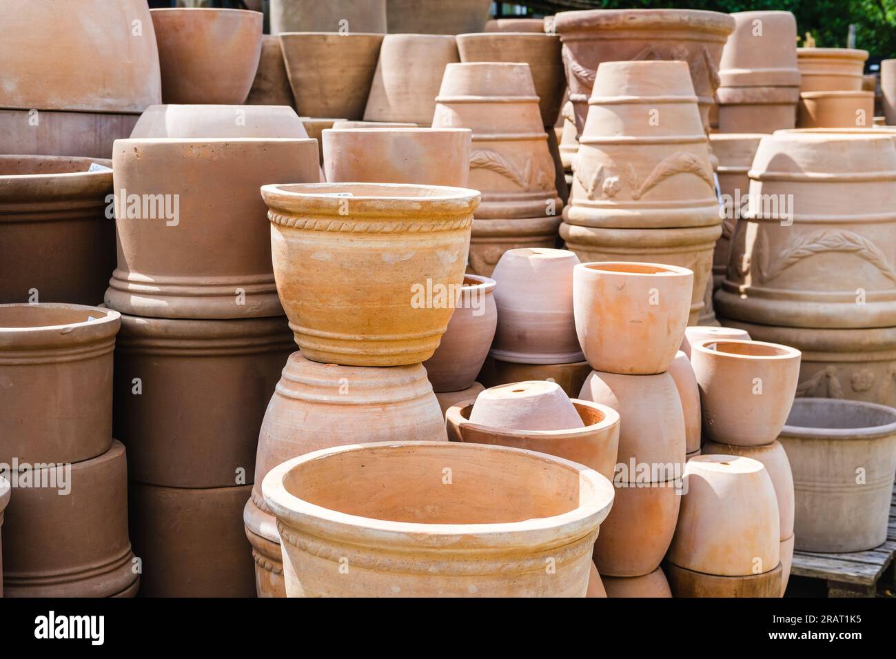 A variety of empty stacked ceramic terra cotta flower pots in different ...