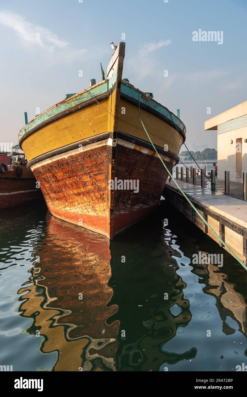 Reflection of a wooden boat in water creating beautiful pattern Stock ...
