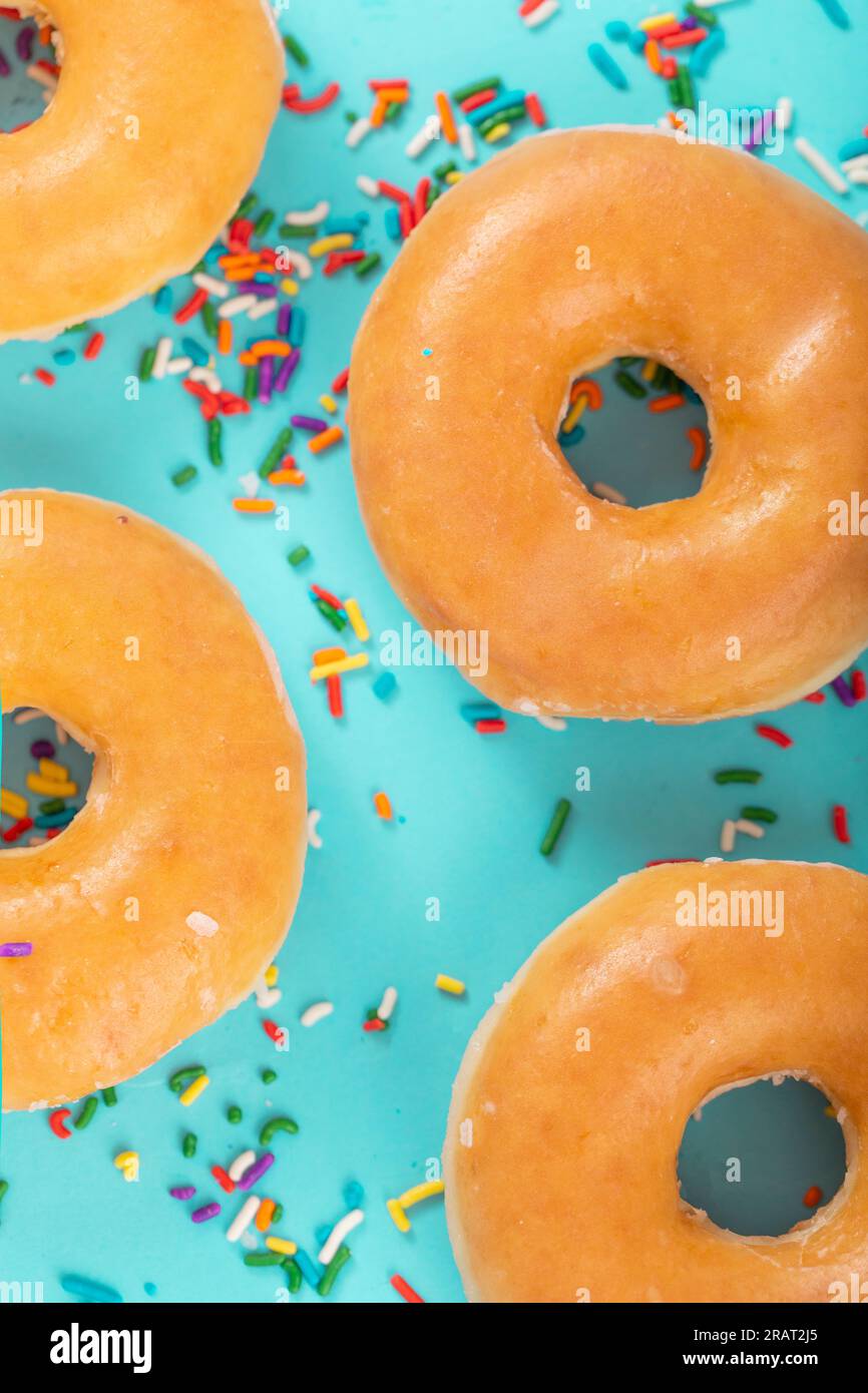 Glazed Donuts with sprinkles Stock Photo - Alamy