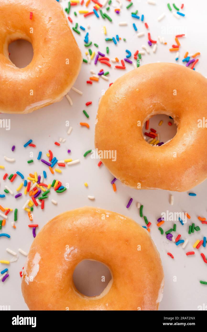 Glazed Donuts with sprinkles Stock Photo - Alamy
