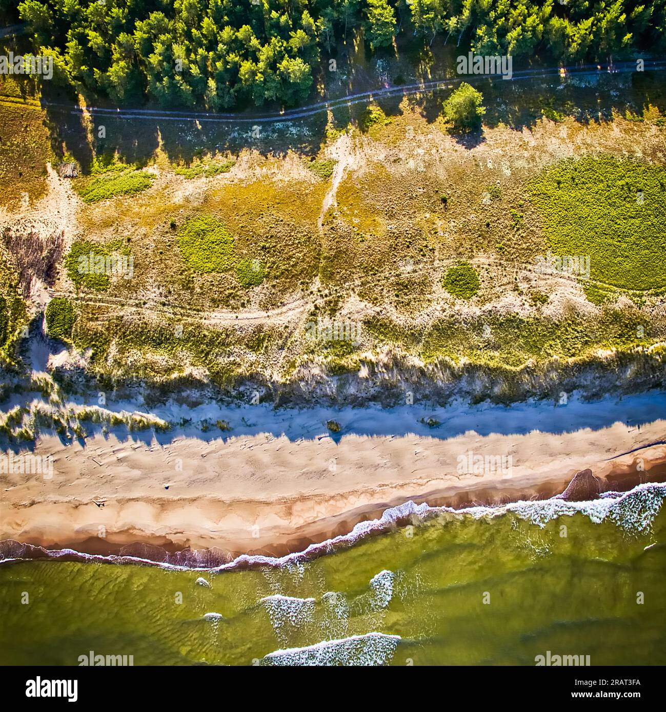 Scenic view down to the shore of curonian spit with green seawater and ...