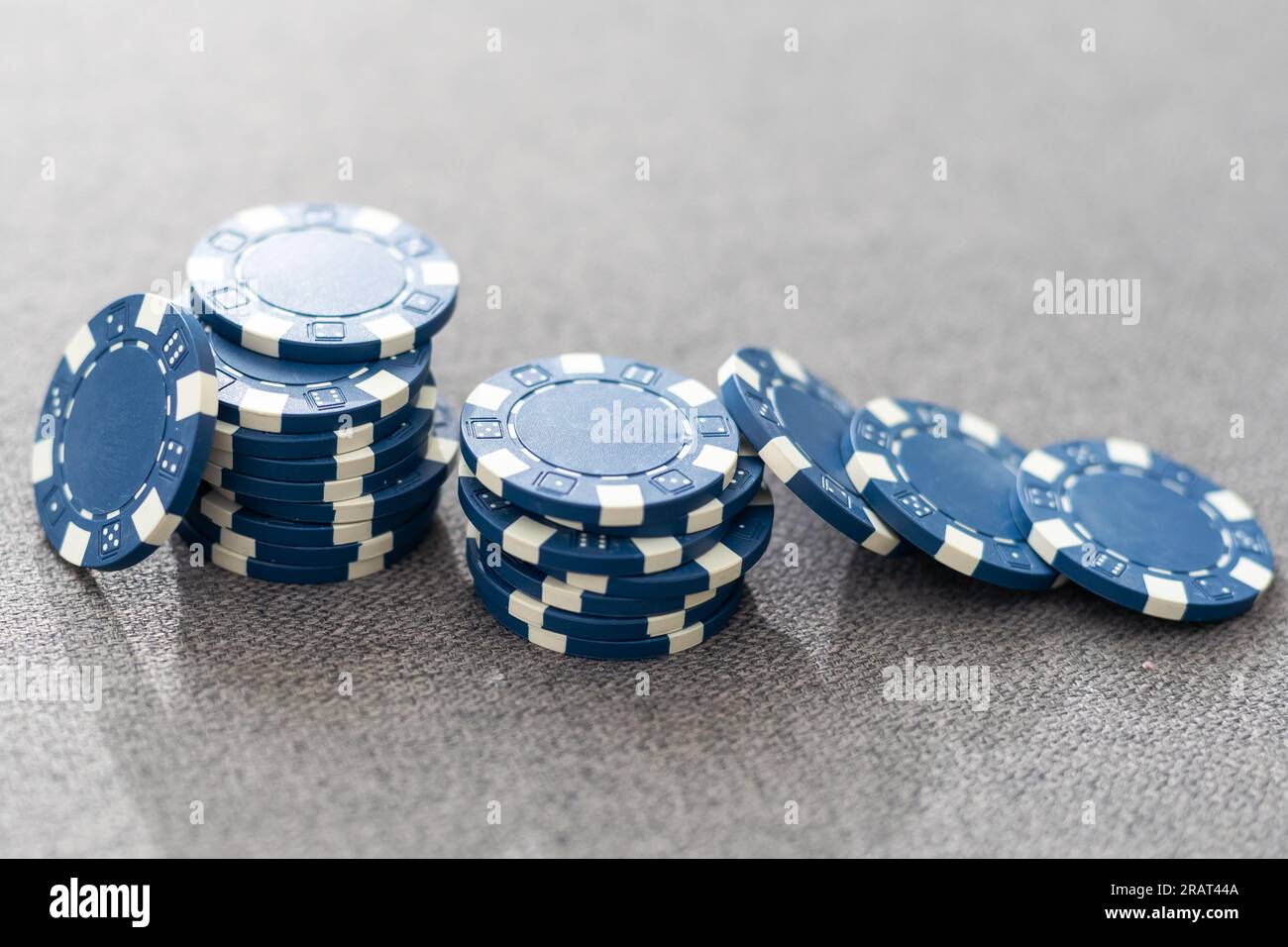 Blue poker chips on stock market chart background Stock Photo - Alamy