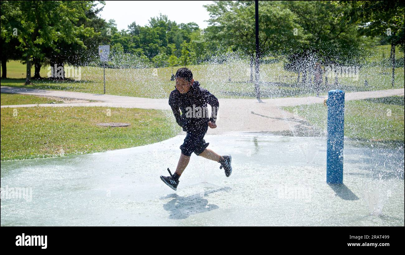 Toronto, Ontario / Canada - 06/30/2022: A hot summer day. Boy running ...