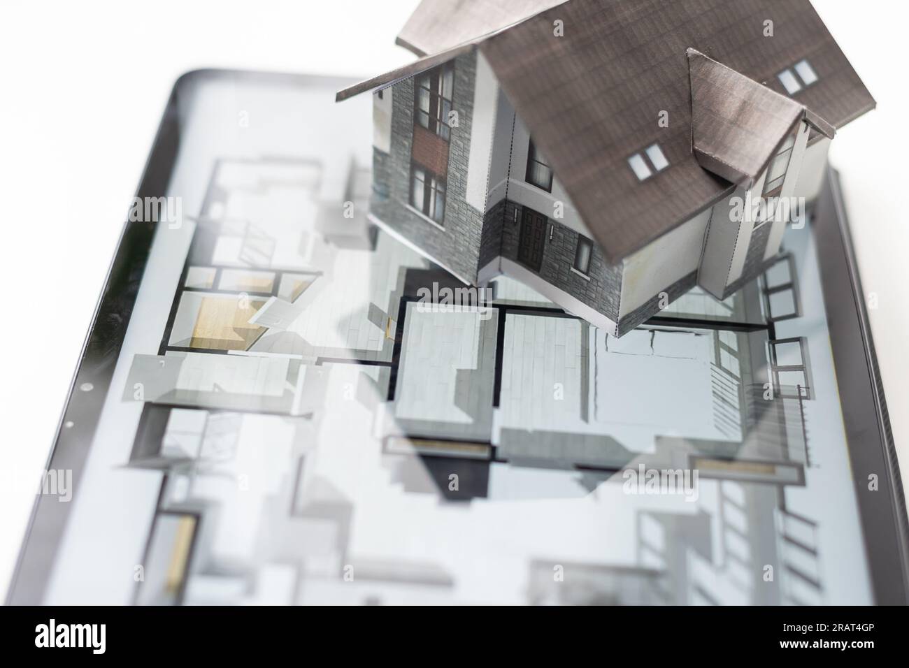 Small house model is on screen tablet and icons home electronics ...