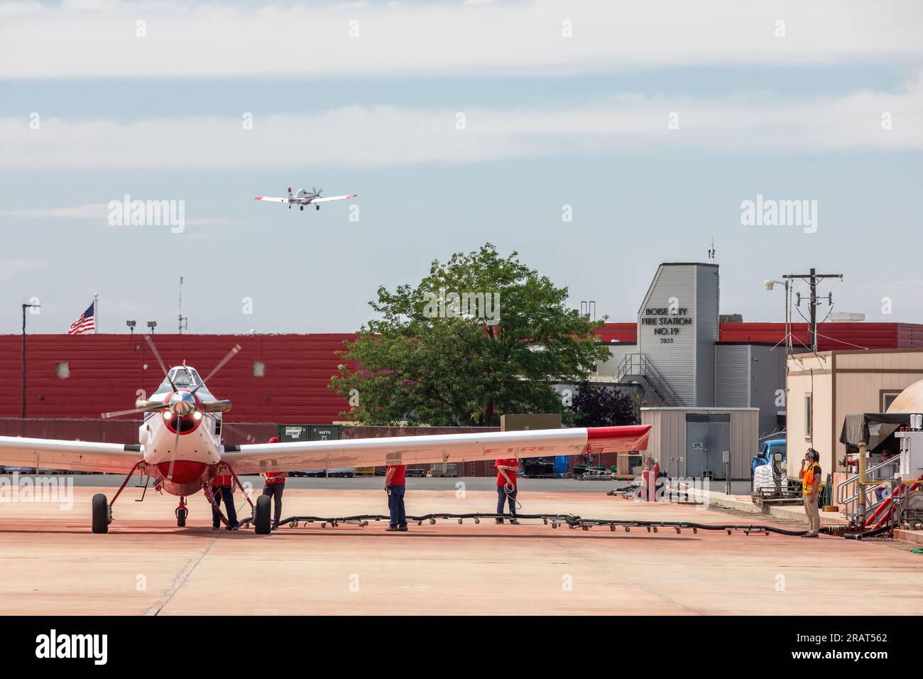 A ground crew loads fire retardant into a single engine air tanker at ...