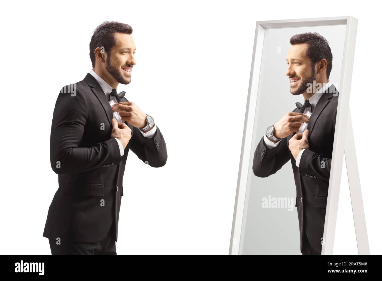 Young elegant man getting ready in front of a mirror isolated on white ...