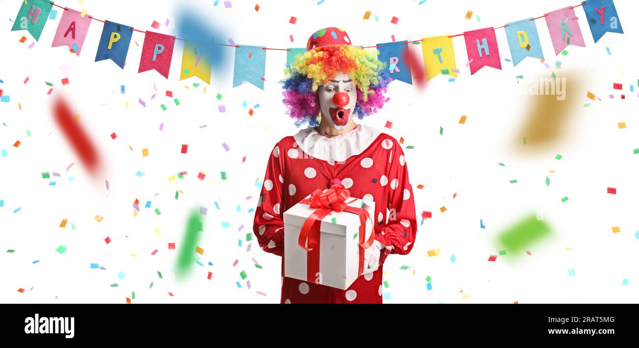 Clown holding a present box under flags with text happy birthday ...