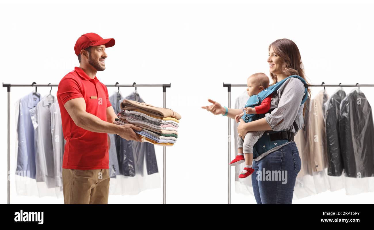 Courier delivering a pile of folded clothes to a mother with a baby ...