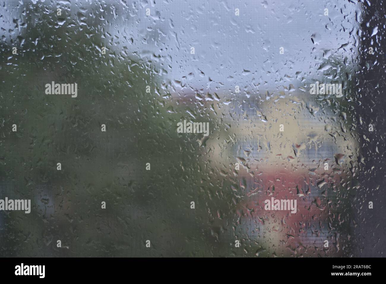 Rain drops on a window glass during a summer storm. Moody, melancholic ...