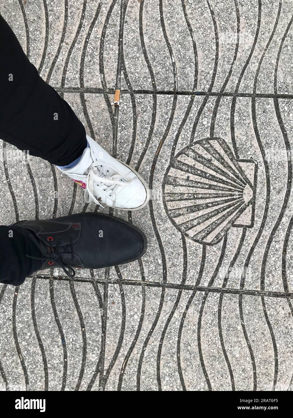 shoes next to the Camino De Santiago sign on the floor tile Stock Photo ...