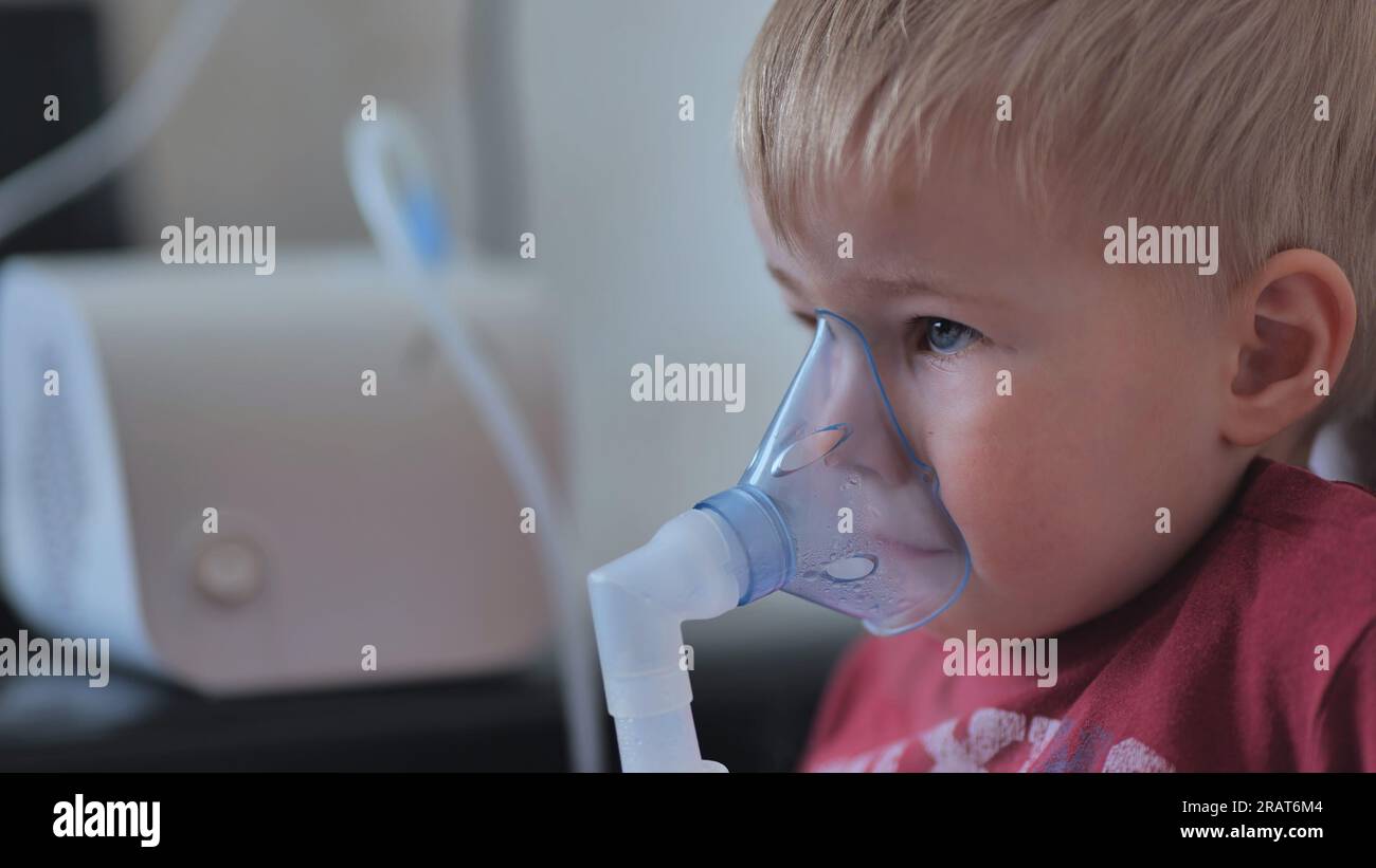 Funny boy breathing through an inhaler mask Stock Photo - Alamy