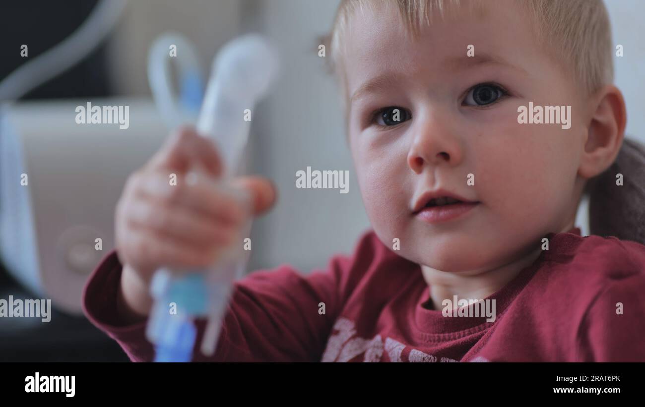 Funny boy breathing through an inhaler mask Stock Photo - Alamy
