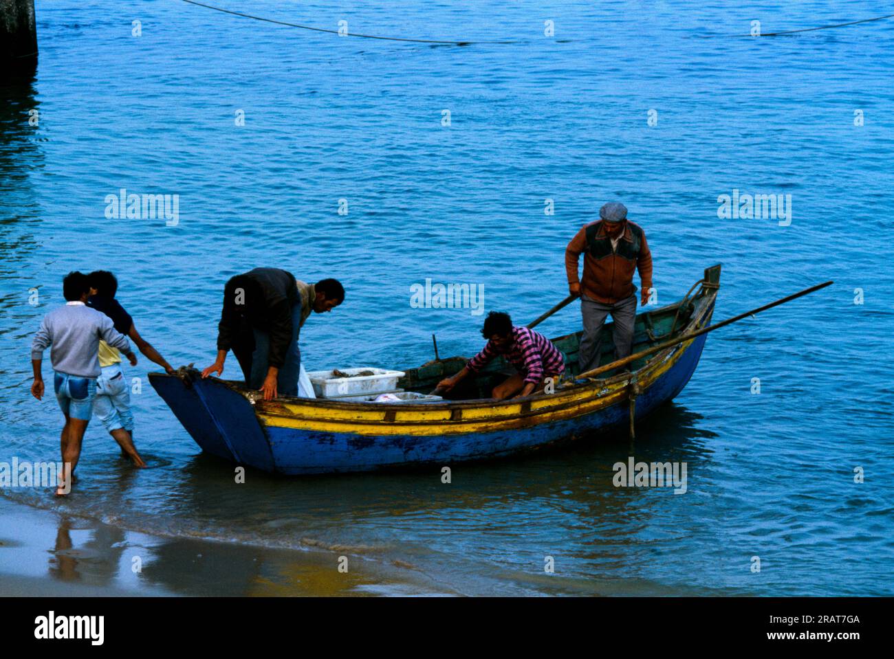 Fishermen unloading fishing boat beach hi-res stock photography and ...