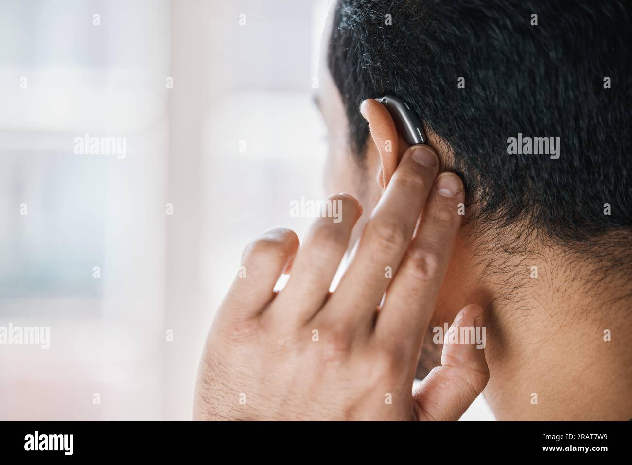 Hearing aid, face and ear of man with disability from the back on ...