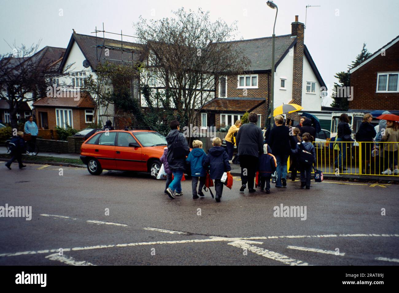 Parents Crossing the Road Taking Children to Primary School and Car ...