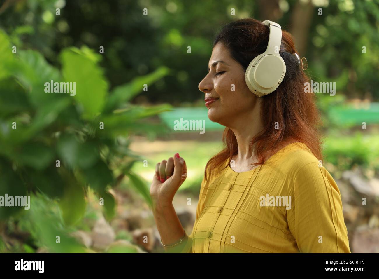 Woman meditating under tree hi-res stock photography and images - Alamy
