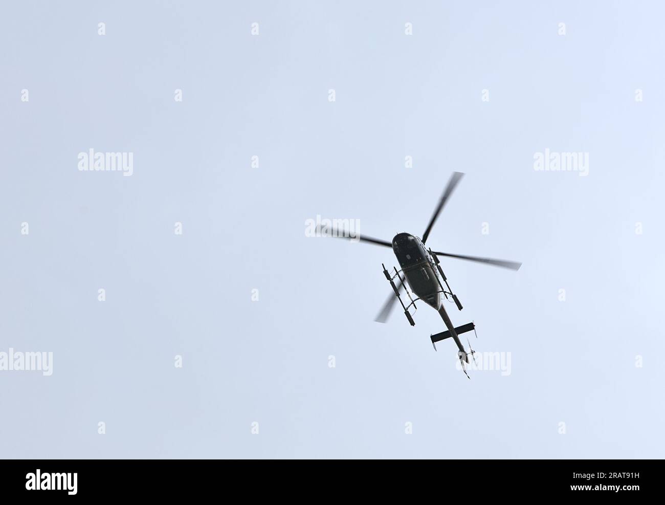 flying helicopter overhead with dark skies background (dark copter ...